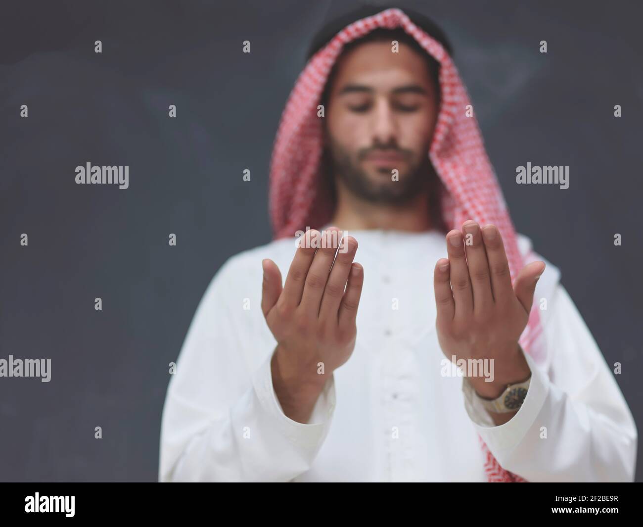 Arab man in traditional clothes praying to God or making dua. Muslim ...