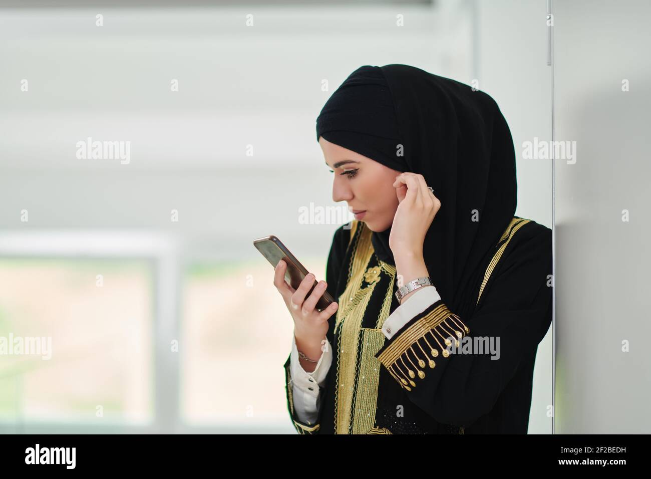Portrait of Arab woman in traditional clothes using mobile phone Stock ...