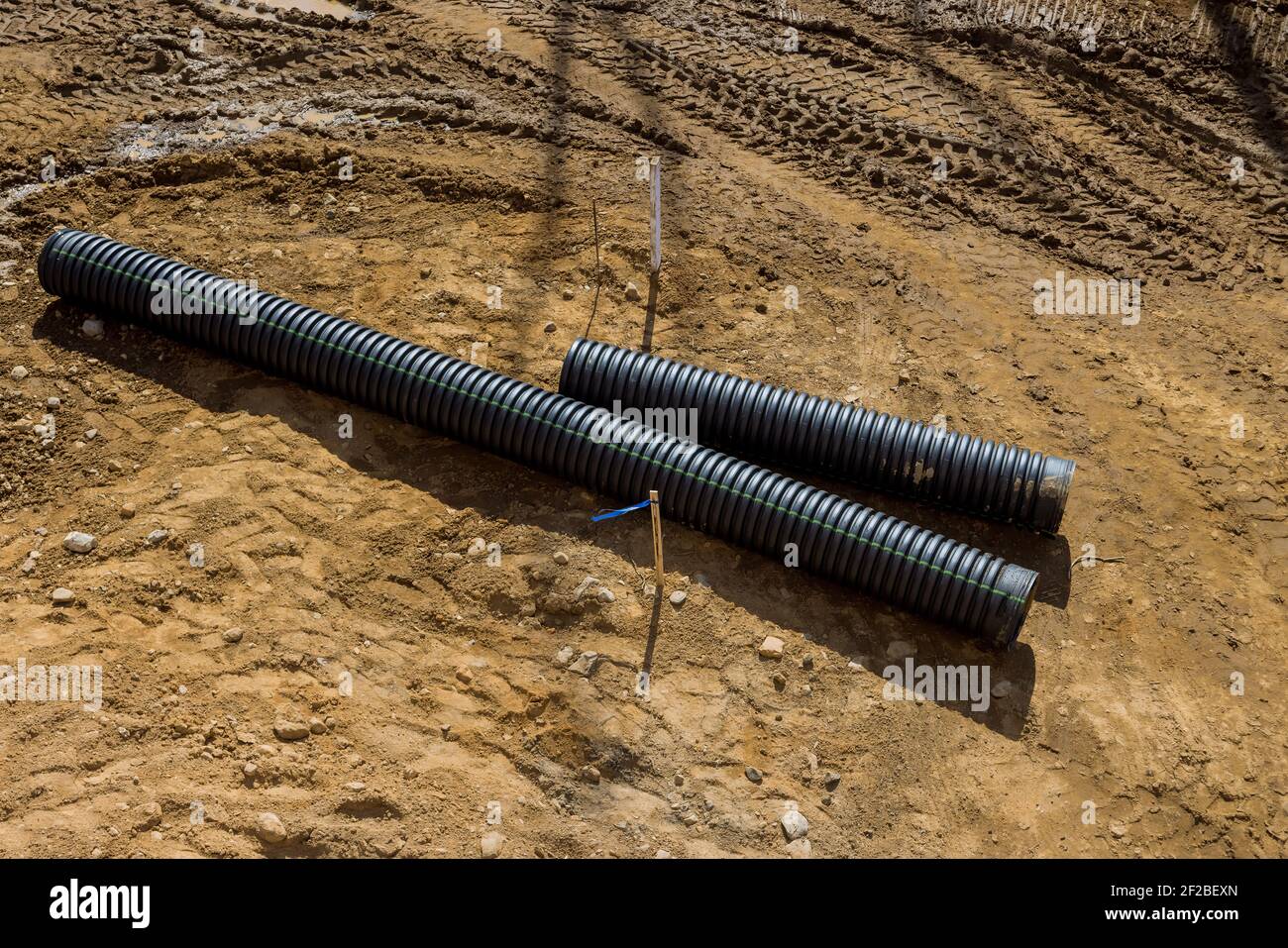 PVC tubes plastic pipes stacked in rows at construction site on ...