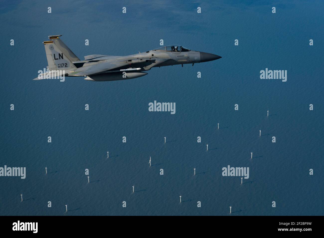 U.S. Air Force F-15C Eagle fighter aircraft, assigned to the 493rd Fighter Squadron, flies above ...