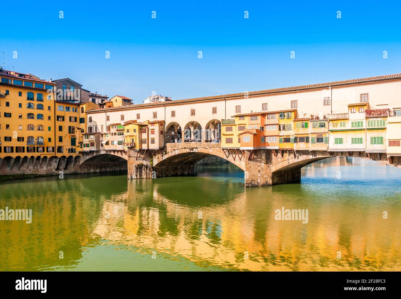 The Ponte Vecchio over the Arno River in Florence in Tuscany, Italy ...