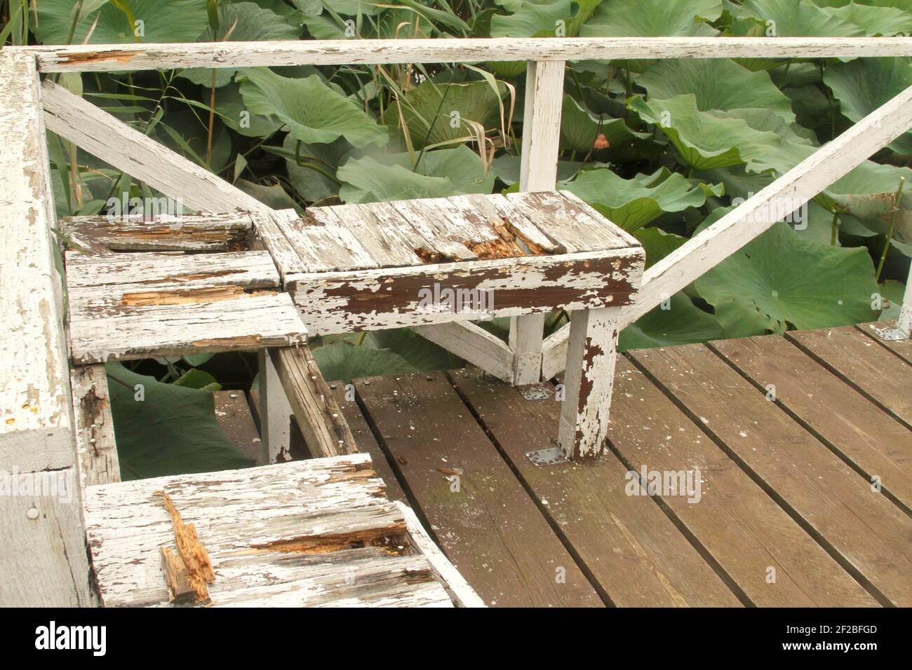 Broken bench on a private deck by the lake Stock Photo - Alamy