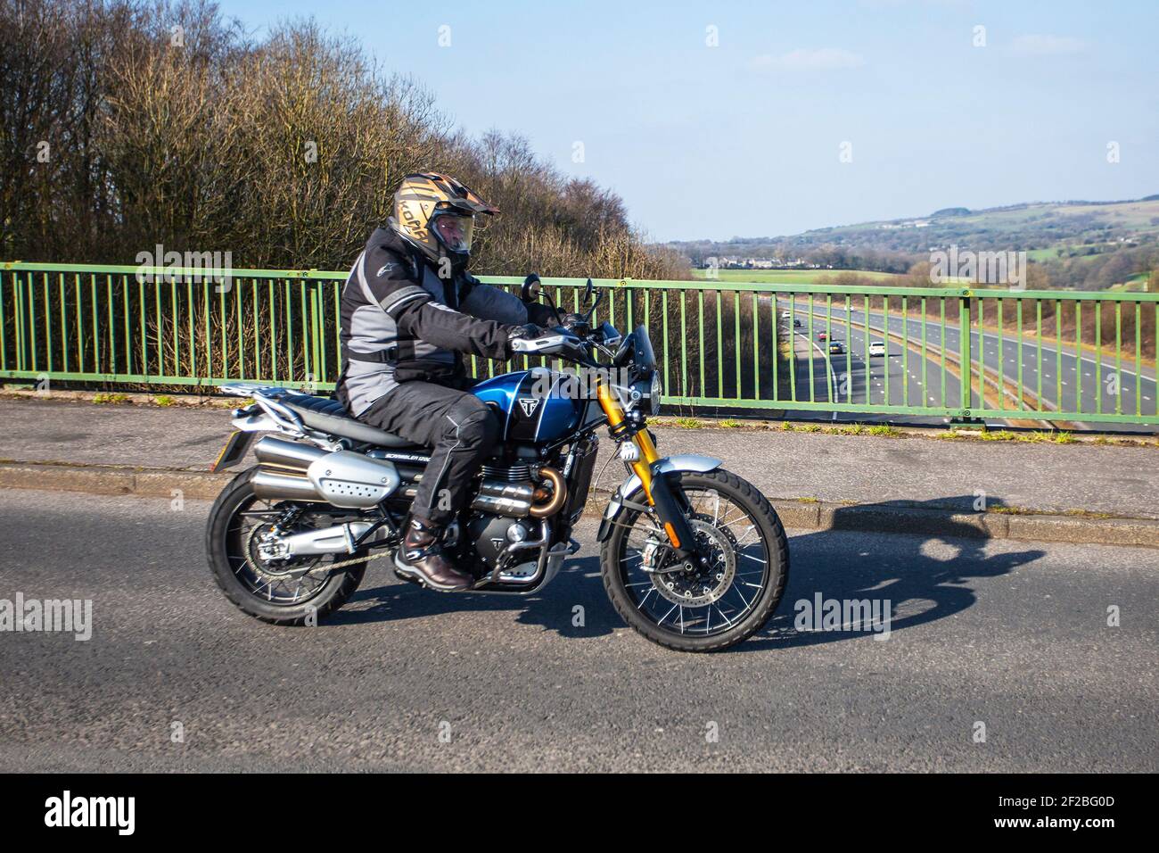 2019 blue Triumph Scrambler 1200 Xe 1200cc; Motorbike rider; two ...