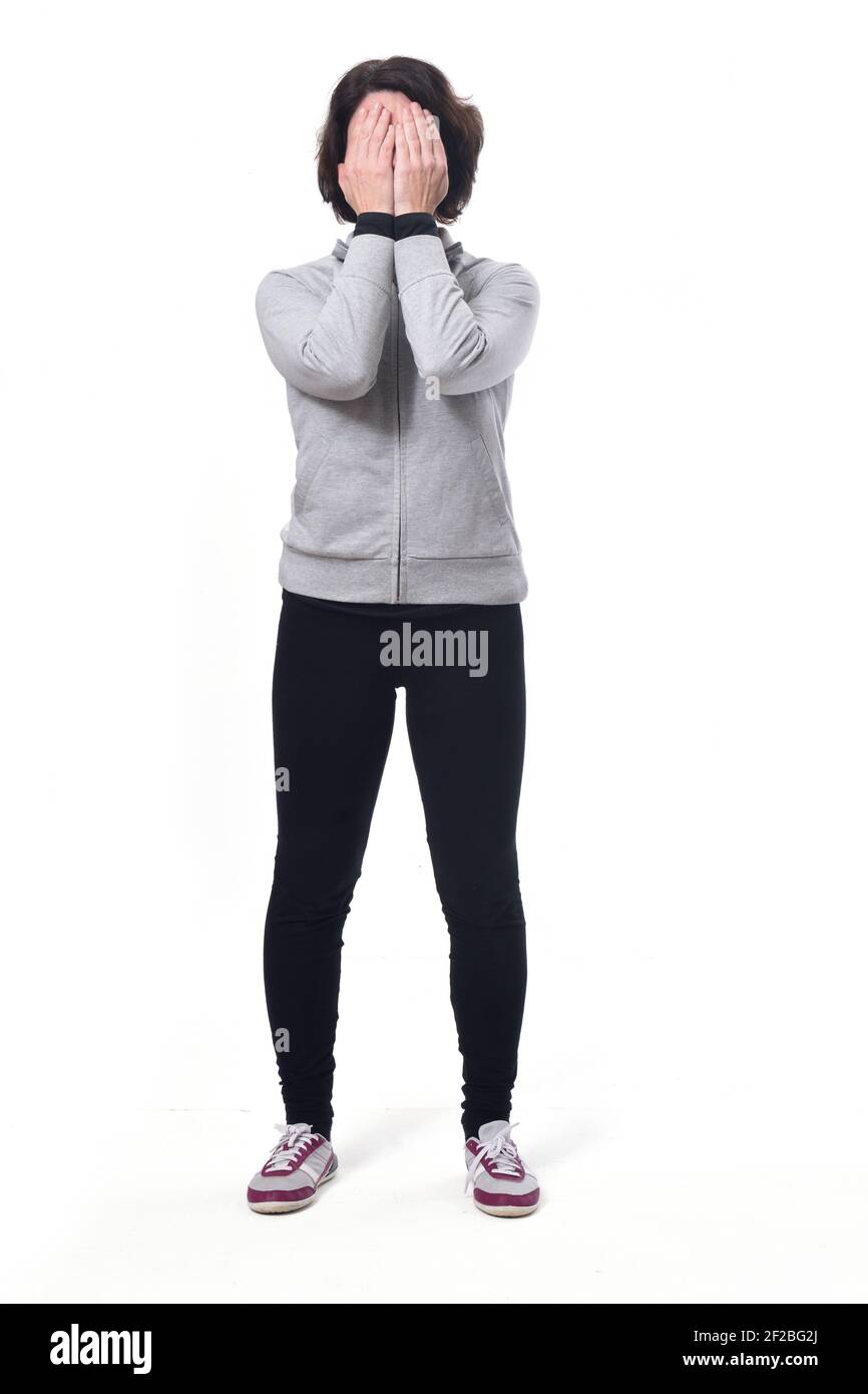 full length portrait of a woman covering face on white background Stock ...