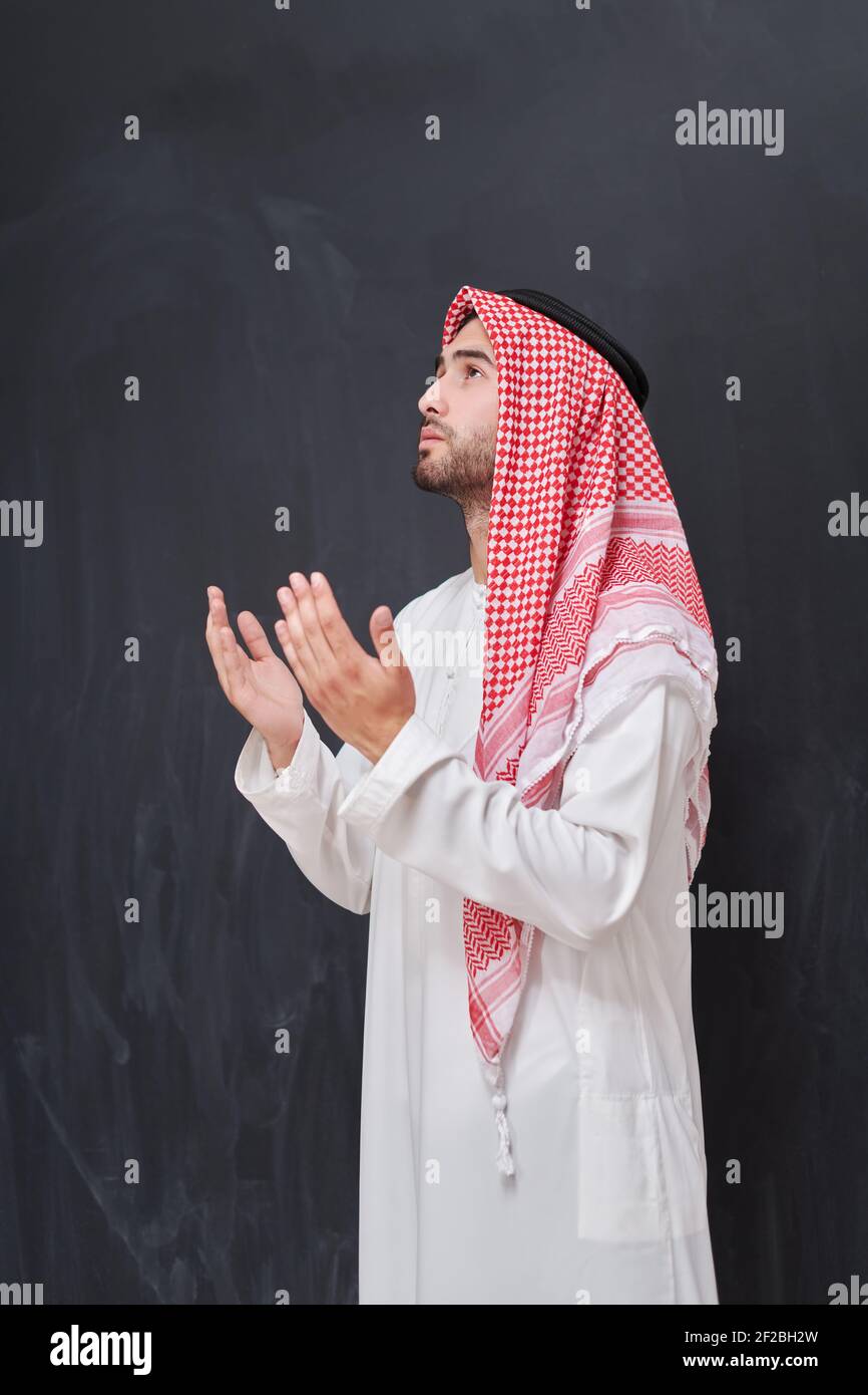 Arab man in traditional clothes praying to God or making dua Stock ...