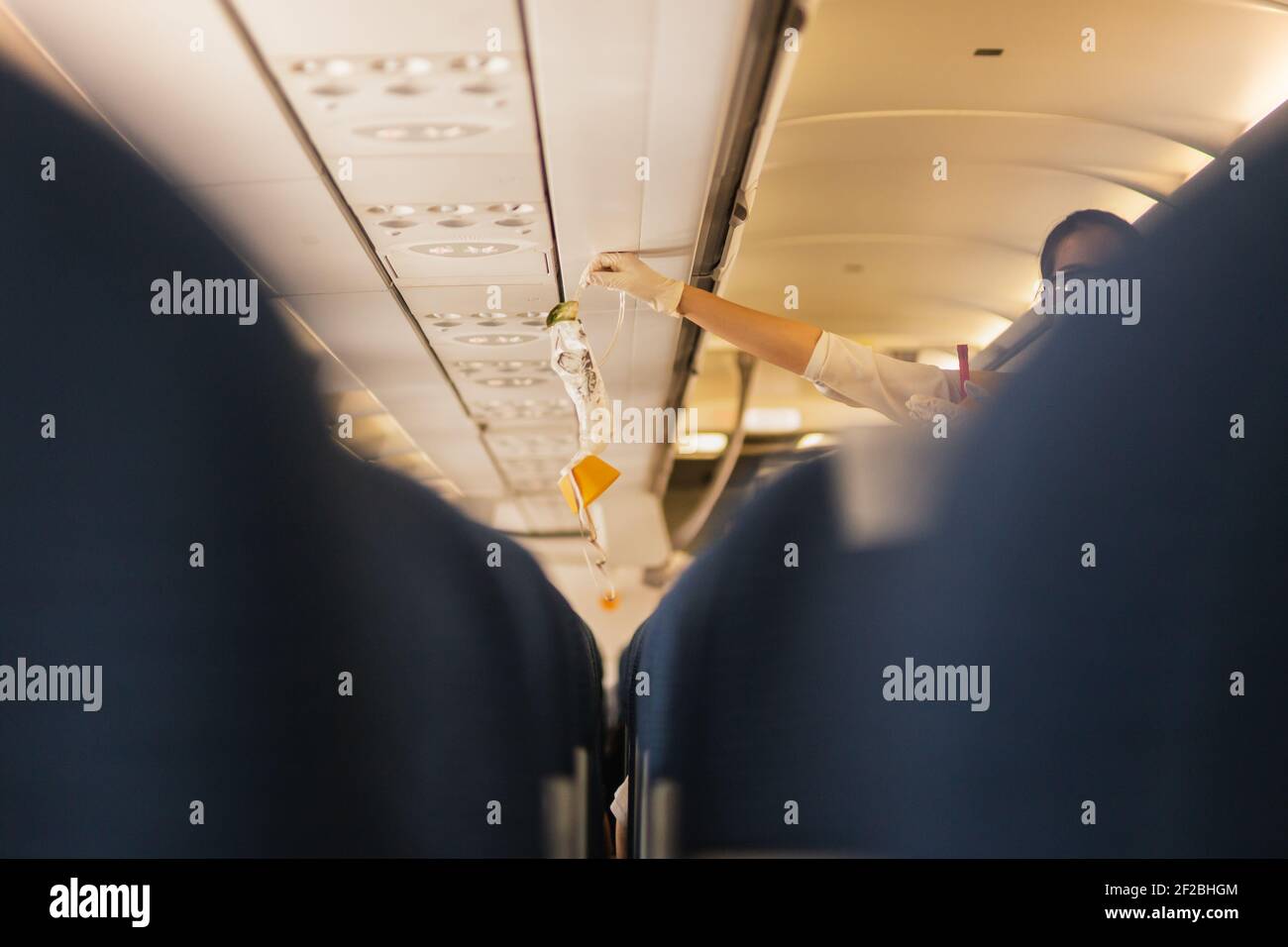 Flight attendant showing how to use oxygen mask before taking off Stock ...