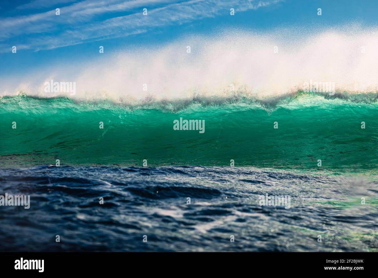 Turquoise waves in ocean. Breaking wave with sun light Stock Photo - Alamy