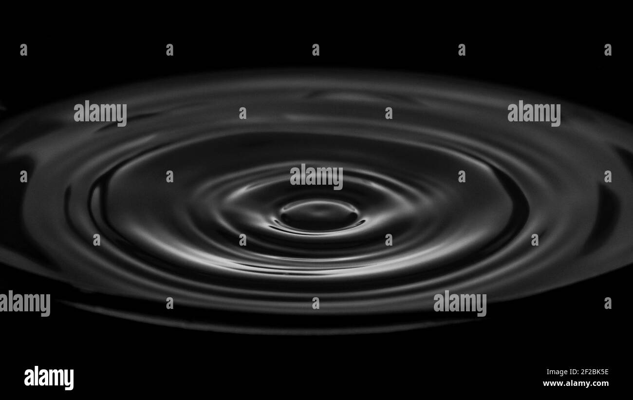 A water drop ripple on a black background Stock Photo - Alamy