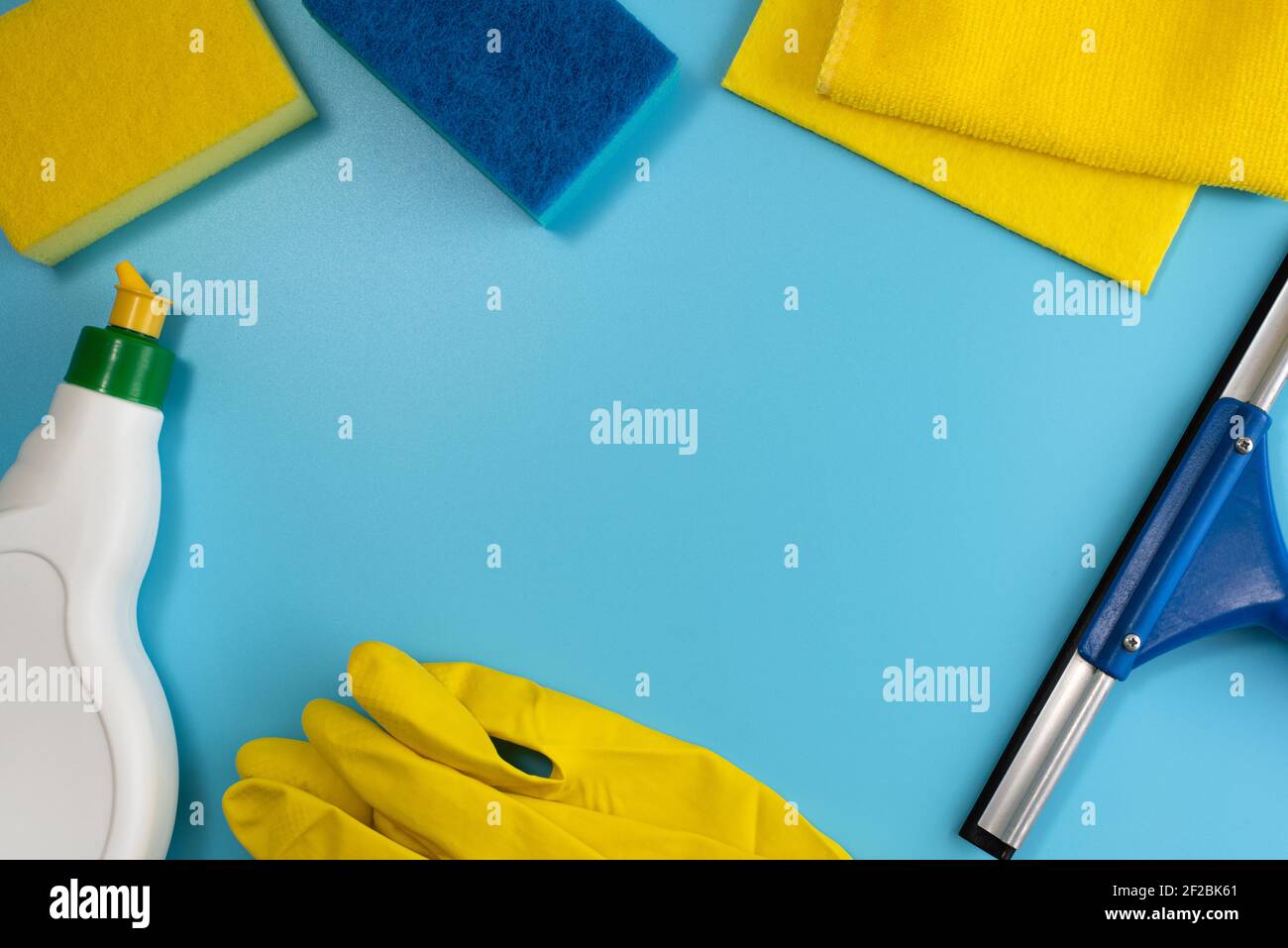 Top view of house cleaning supplies: rubber gloves, sponges, cloths ...