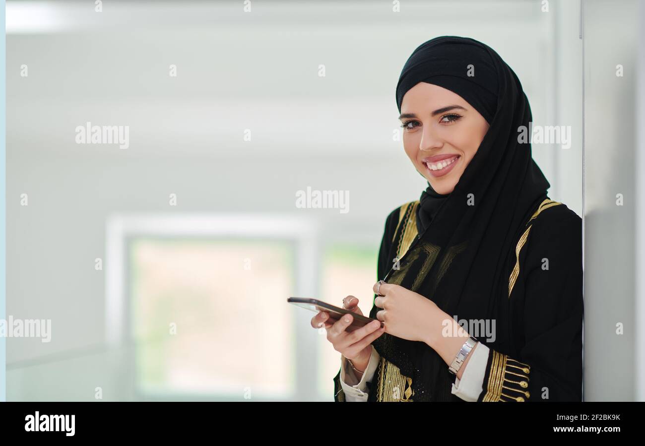 Portrait of Arab woman in traditional clothes using mobile phone Stock ...