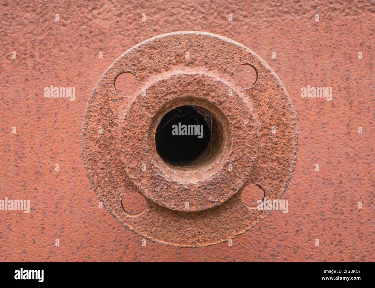 The rusty element of the old construction hole is overgrown with ...