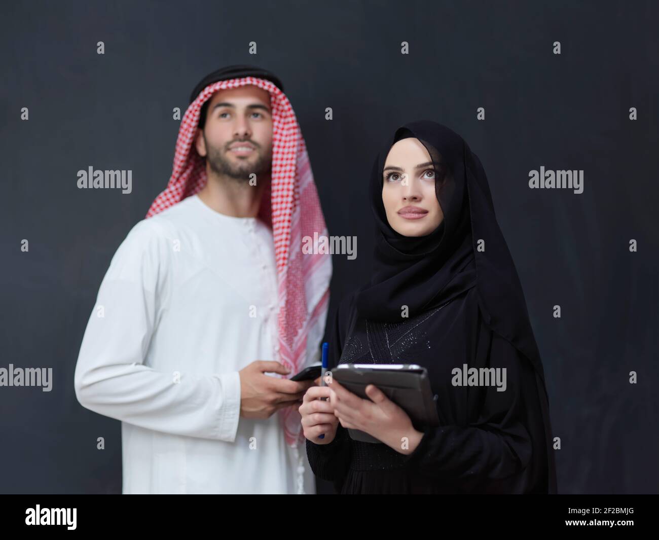 Young muslim business couple using technology devices. Successful Arabs ...