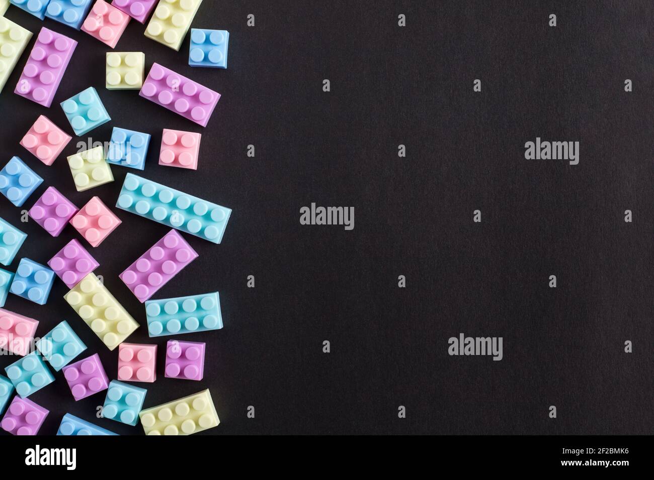 Building blocks on black background with empty space on one side Stock ...