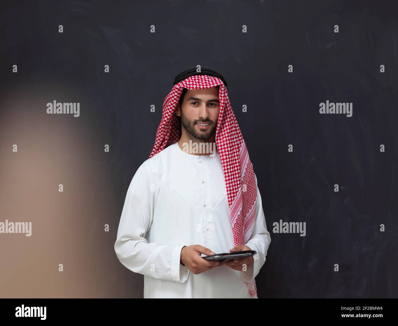 Portrait of young muslim businessman using tablet. Successful Arab boy ...