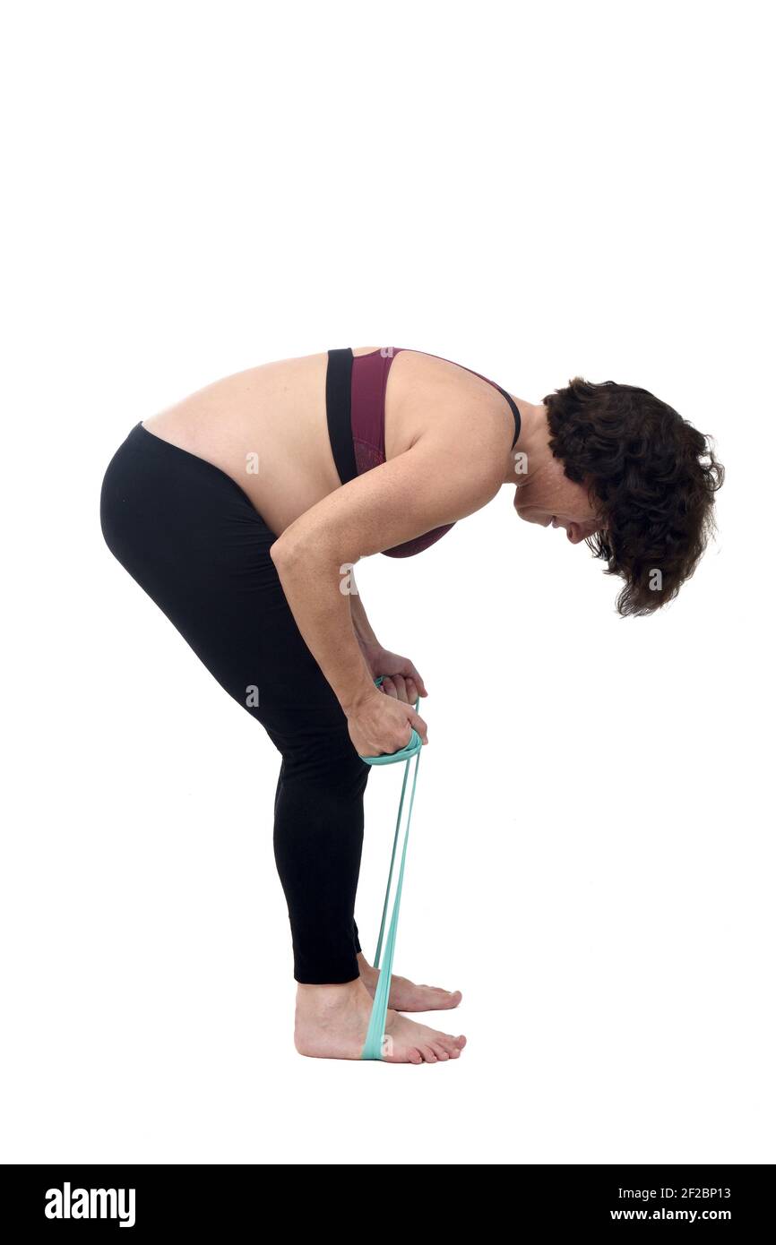 sideways of a pregnant woman standing doing exercise resistance bands ...
