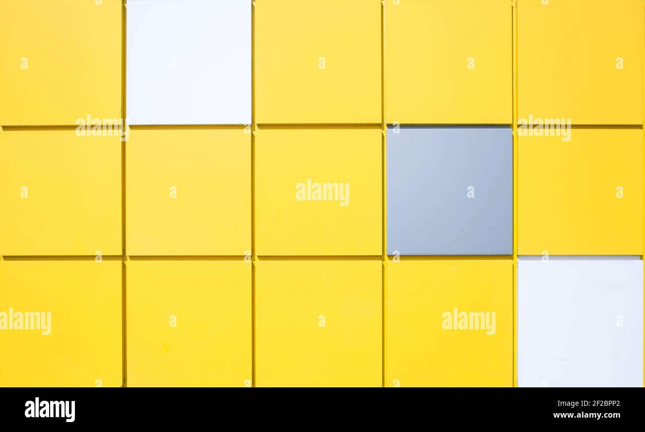 Bright yellow, white and gray square plastic wall panels. Modern trendy ...