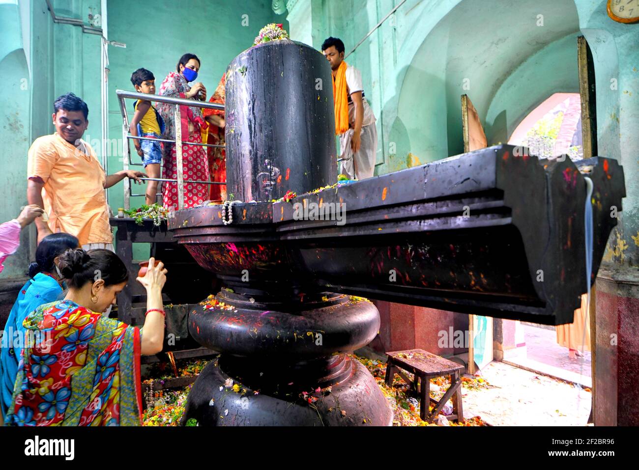 Hindu devotees seen pouring milk and water on the idol of Lord Shiva ...