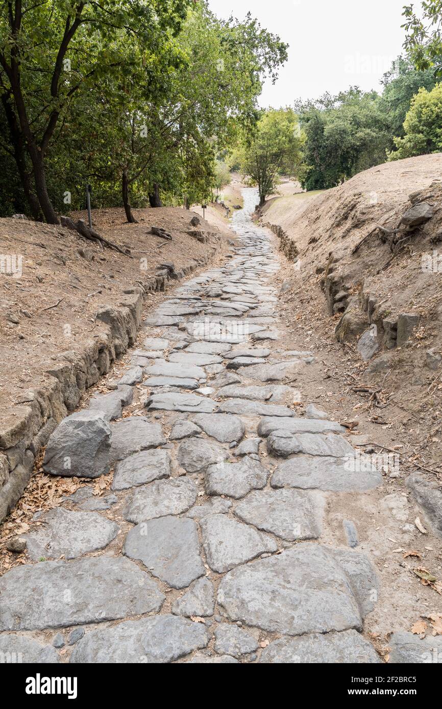 Ancient roman road in the archeological site of Cuma, Campania, Italy ...