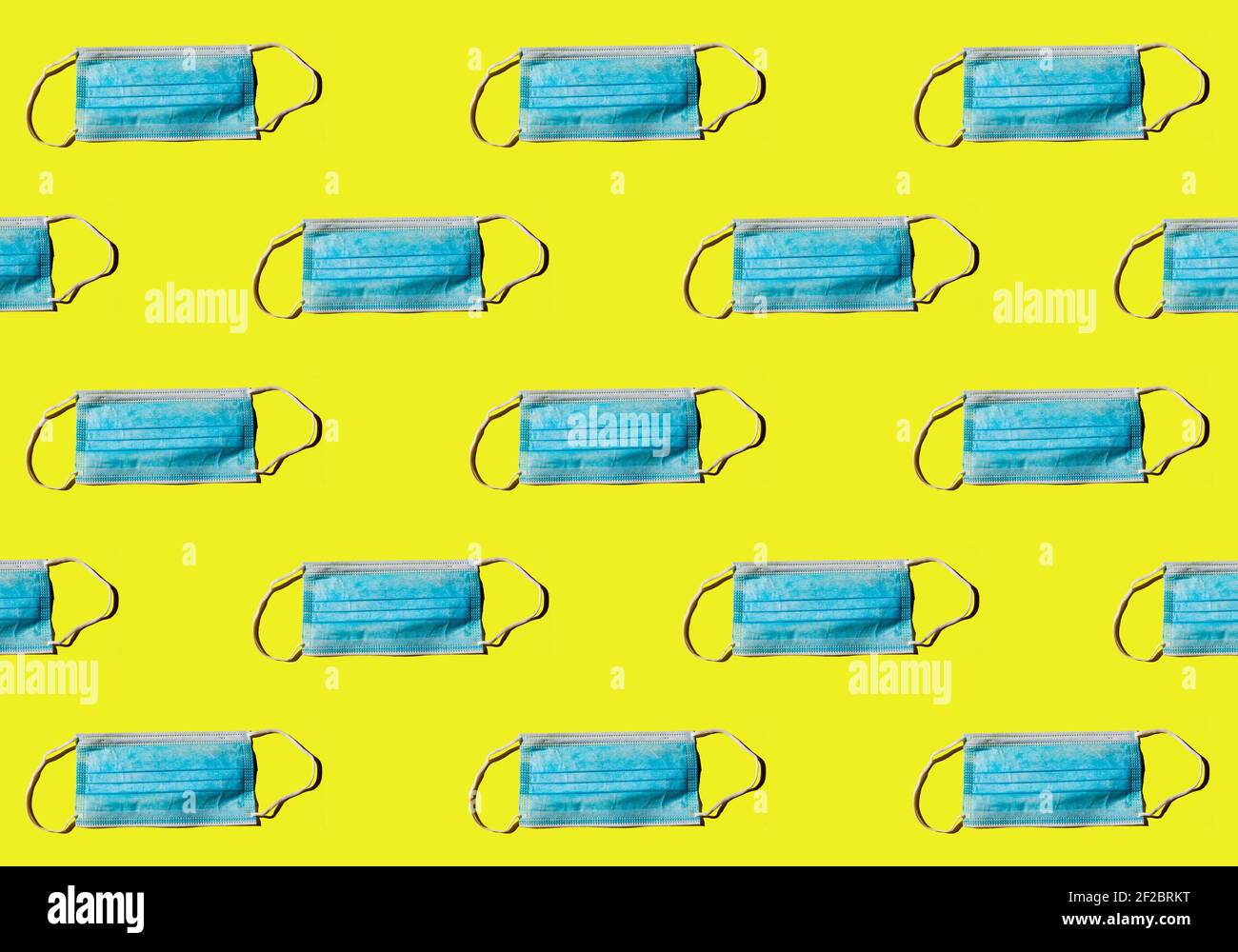 Surgical masks pattern in straight lines on yellow background ...