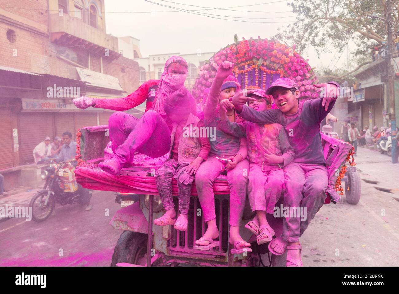 India, Mathura - Boys throwing colored powder in the Holi procession in ...