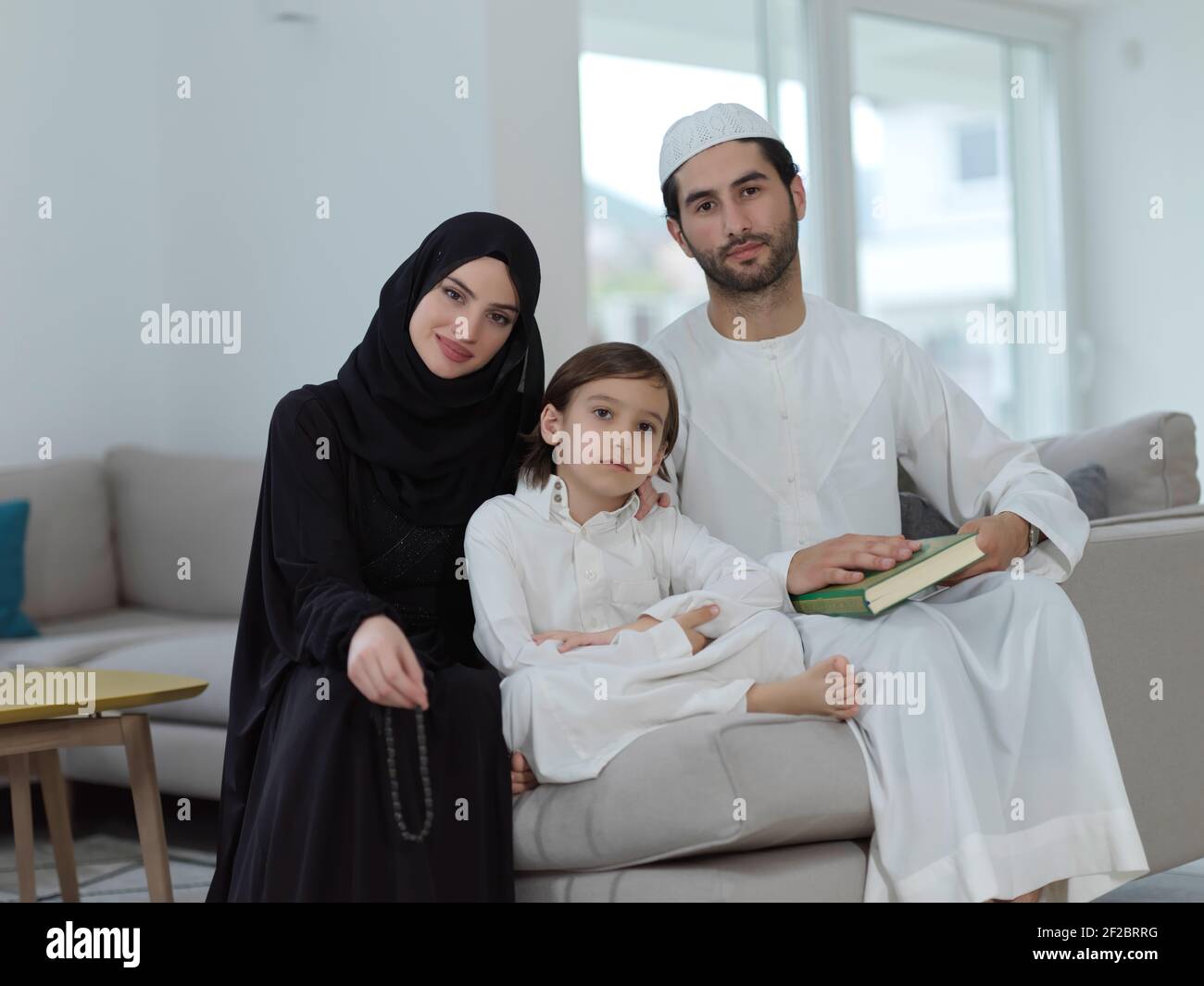 Young muslim family reading Quran during Ramadan. Parents and son ...