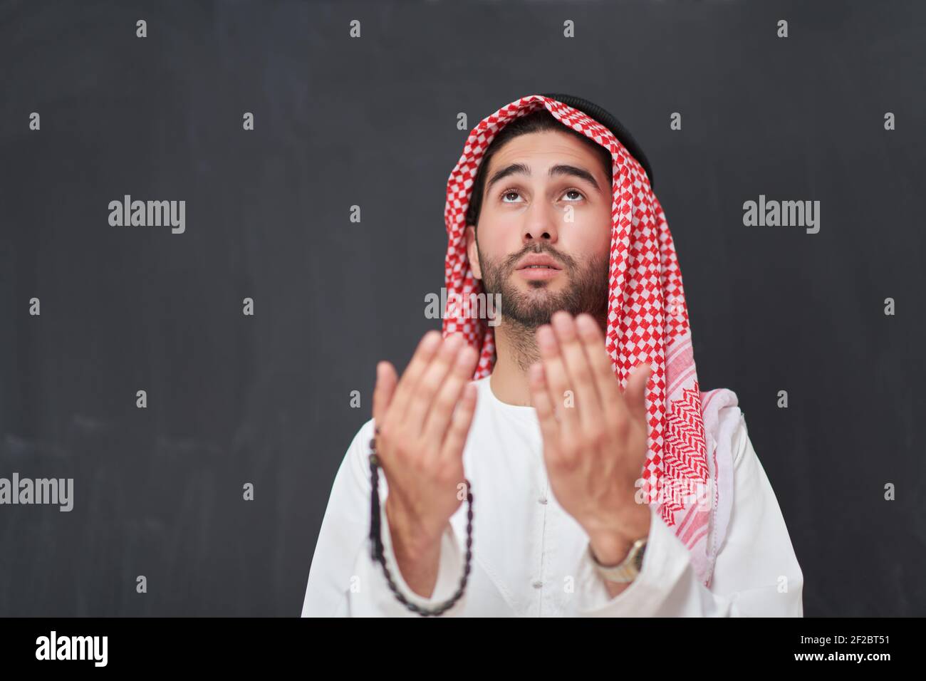 Arab man in traditional clothes praying to God or making dua Stock ...