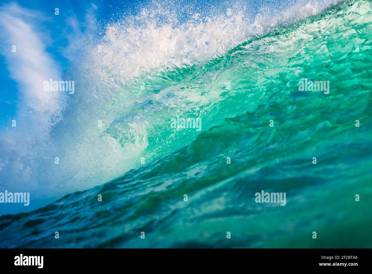 Turquoise waves in ocean. Breaking wave with sun light Stock Photo - Alamy