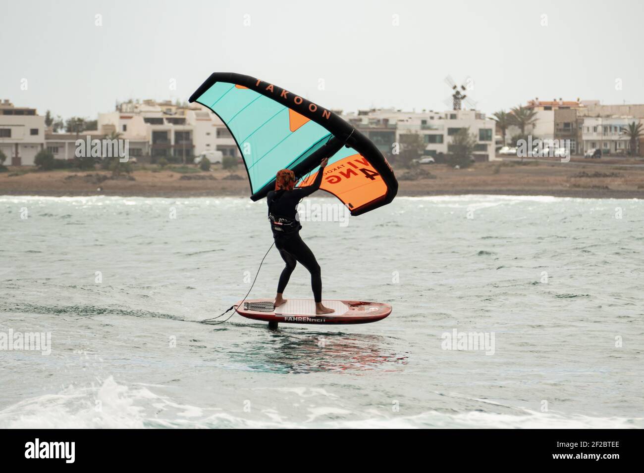 Wing surfer riding on hydrofoil board Stock Photo - Alamy