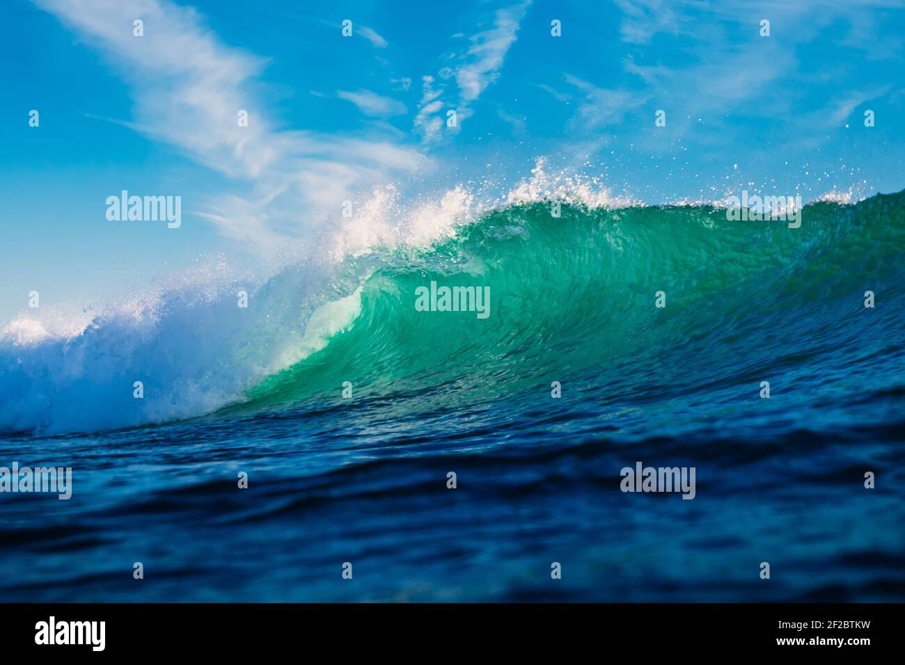 Turquoise waves in ocean. Breaking wave with sun light Stock Photo - Alamy
