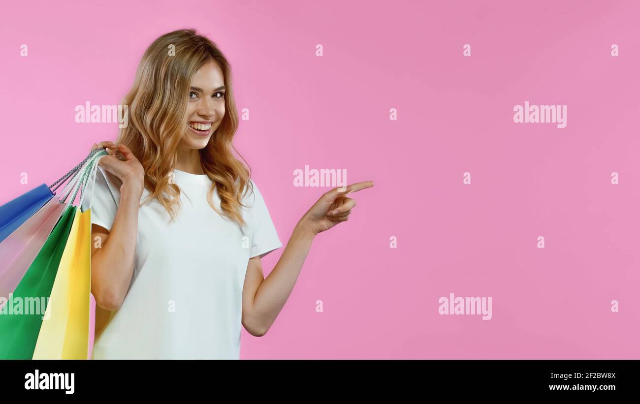 Blonde woman pointing finger shopping hi-res stock photography and ...