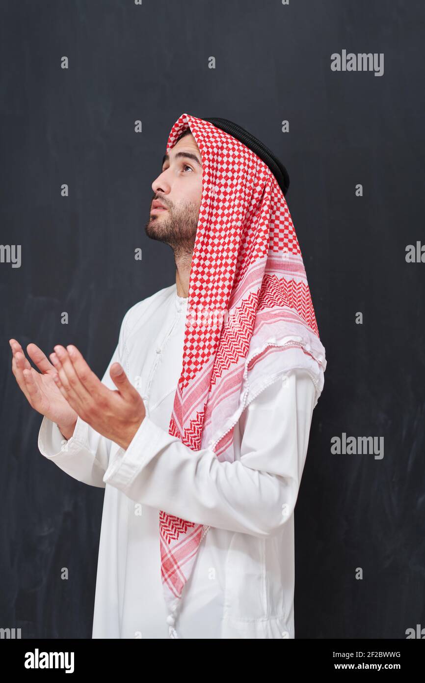 Arab man in traditional clothes praying to God or making dua Stock ...
