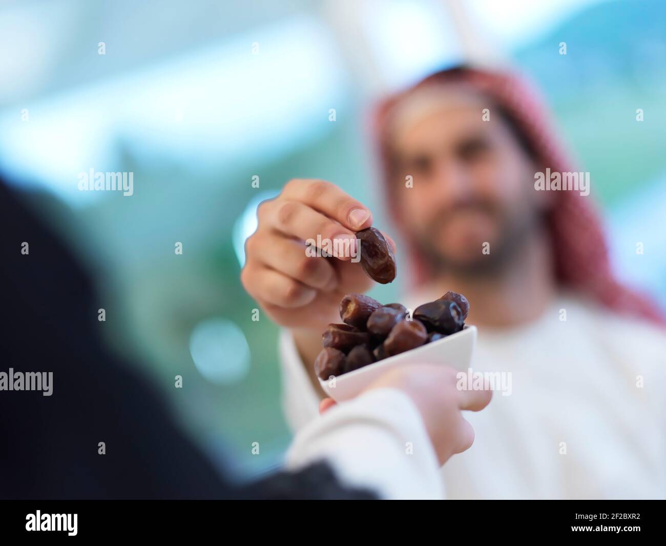 Muslim couple sharing dates for starting iftar. Arabian woman serving ...
