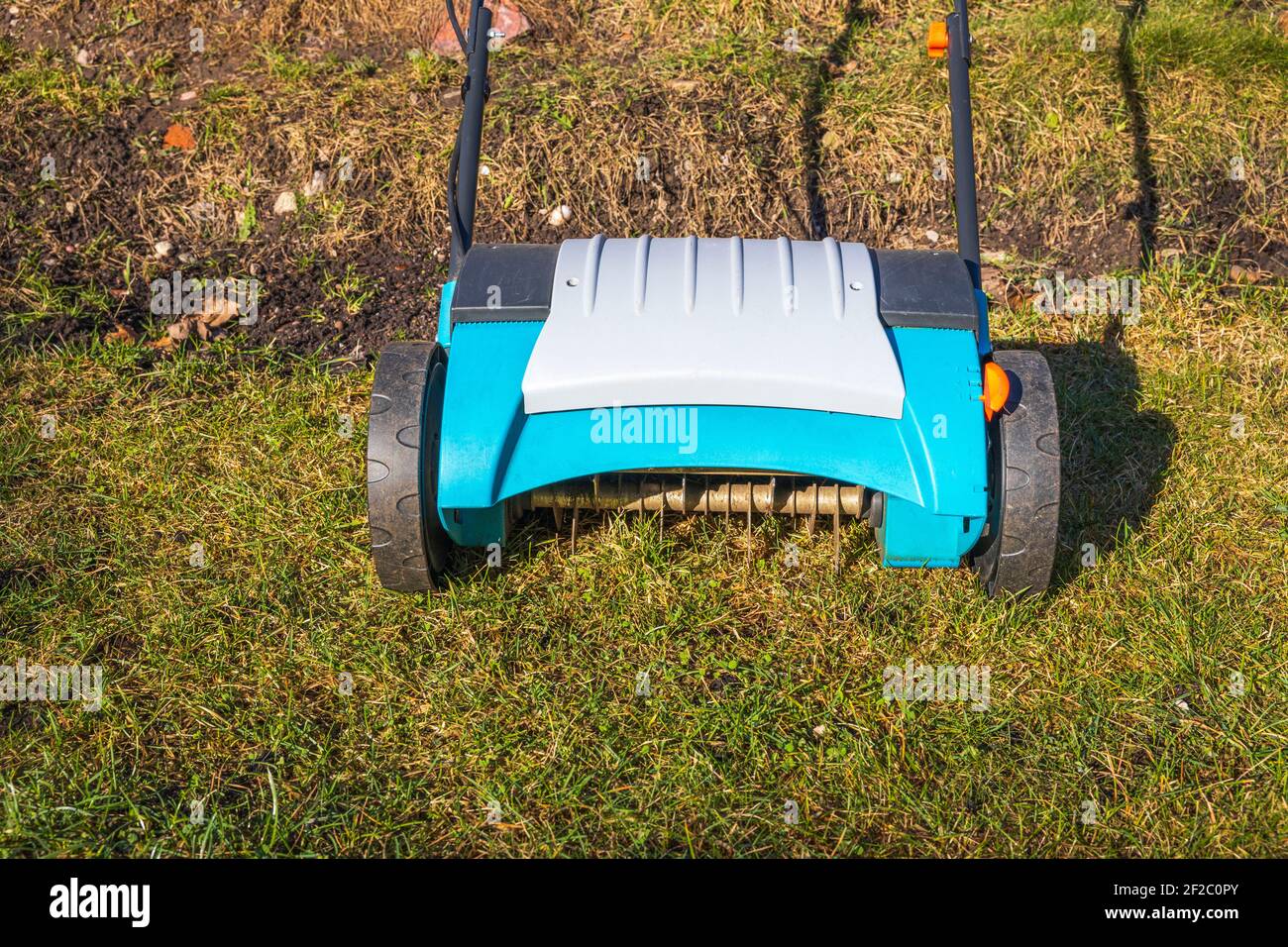 View of electric lawn aerator on green grass isolated. Garden machines ...