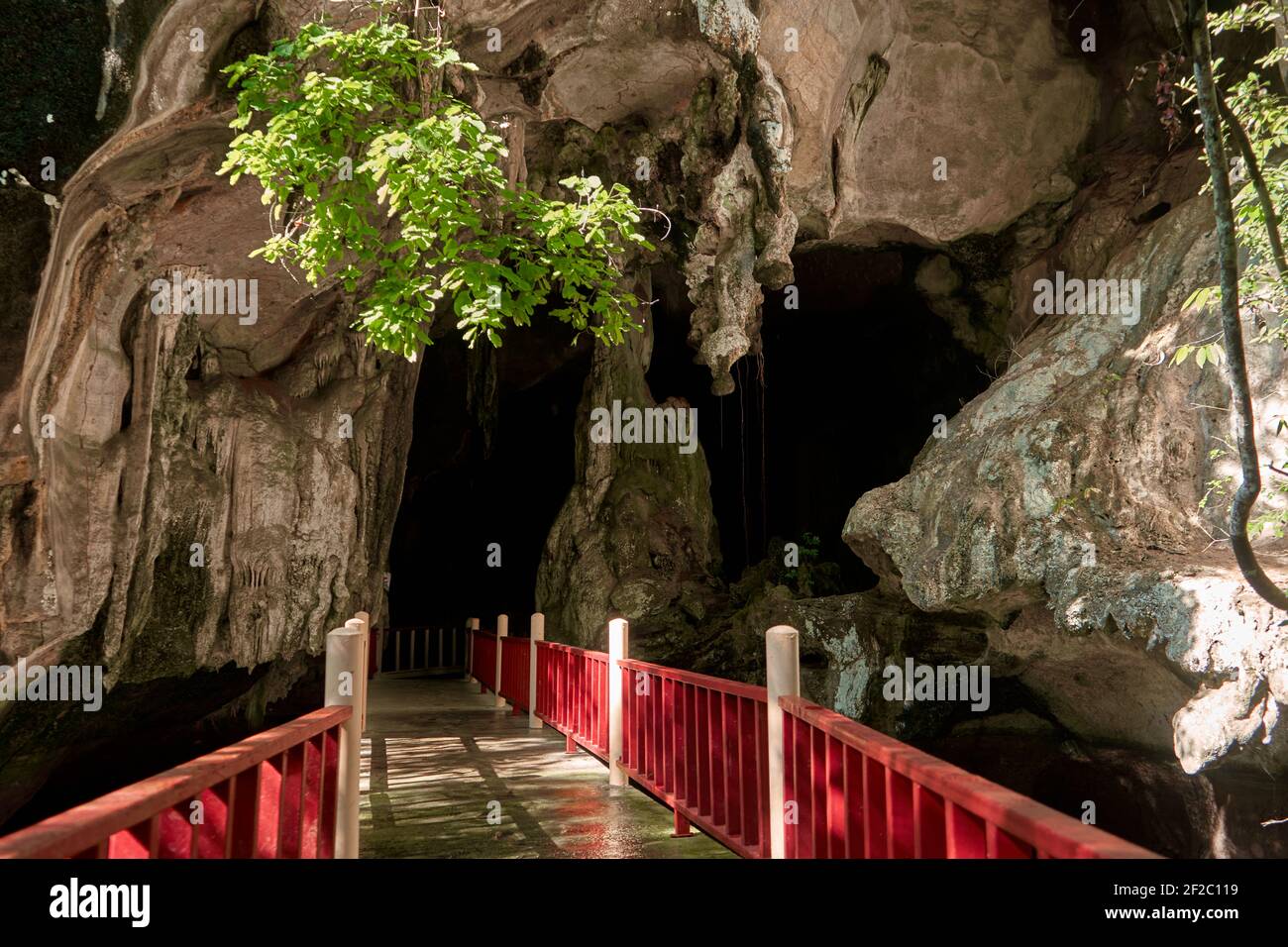 Old stone bat cave in the rock. Tourist attraction. Walk in the cave ...