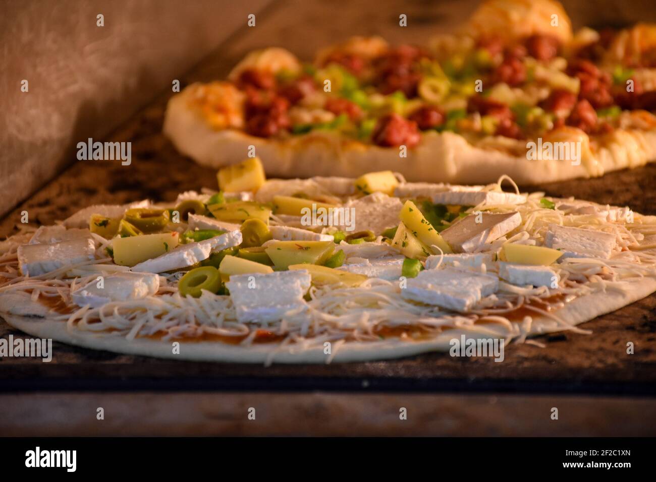 Italian pizza cooking in a modern oven, Mediterranean dishes concept ...