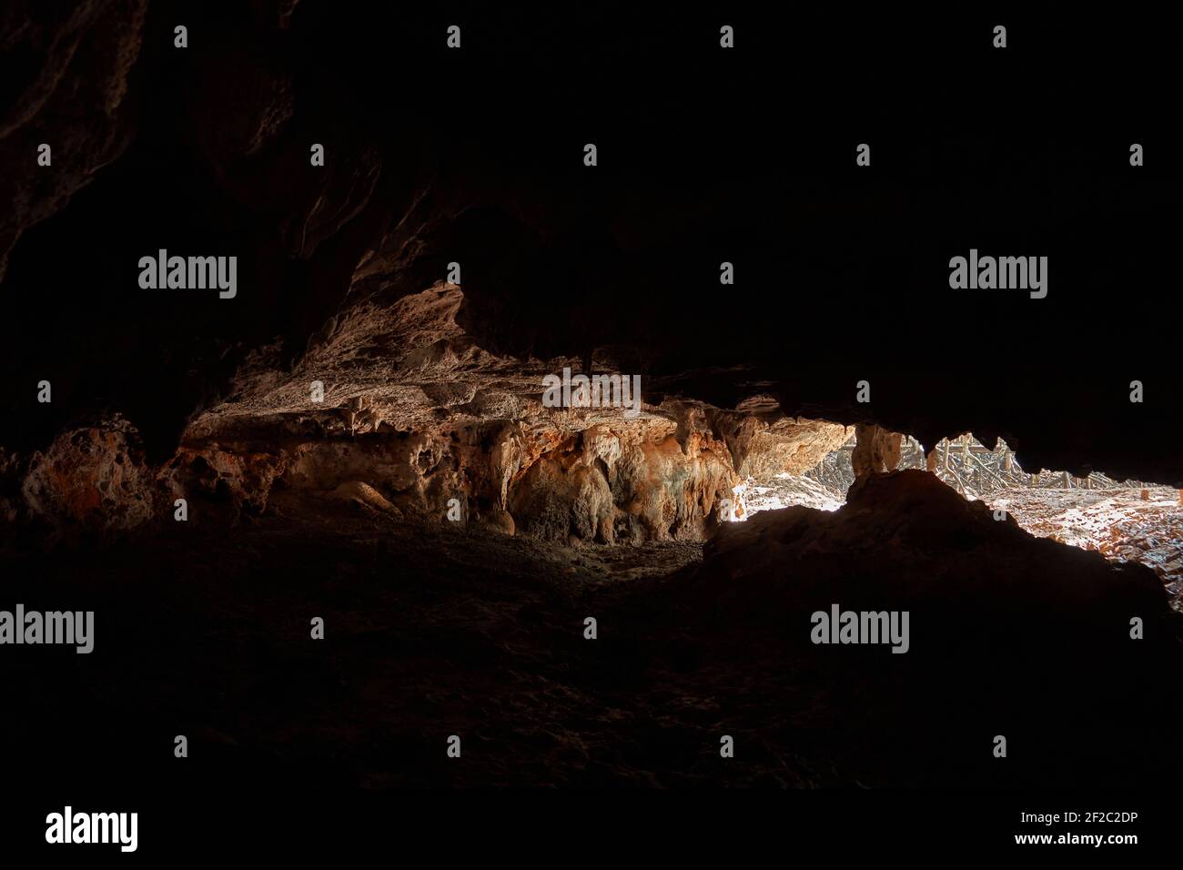 Old stone bat cave in the rock. Tourist attraction. Walk in the cave ...