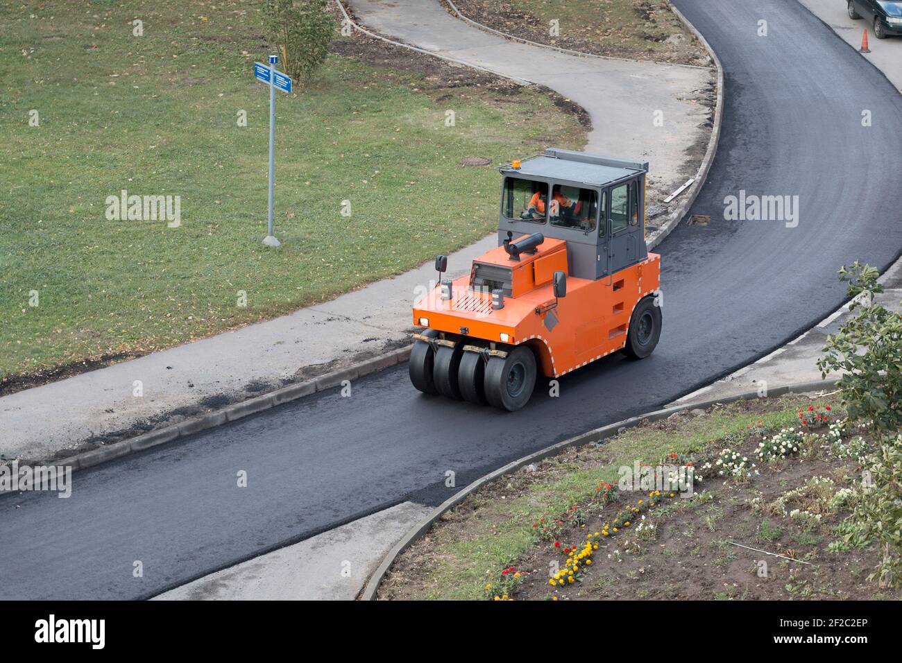 Roller compactor during operation. Road renewal process, compacting ...