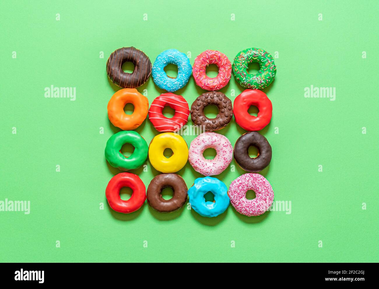 Multicolored icing doughnuts arranged symmetrically in a square on a ...