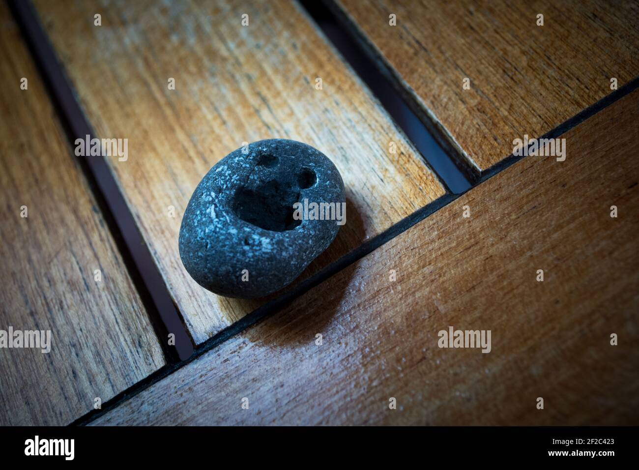 Pebble stone looking like smiling, screaming face Stock Photo - Alamy