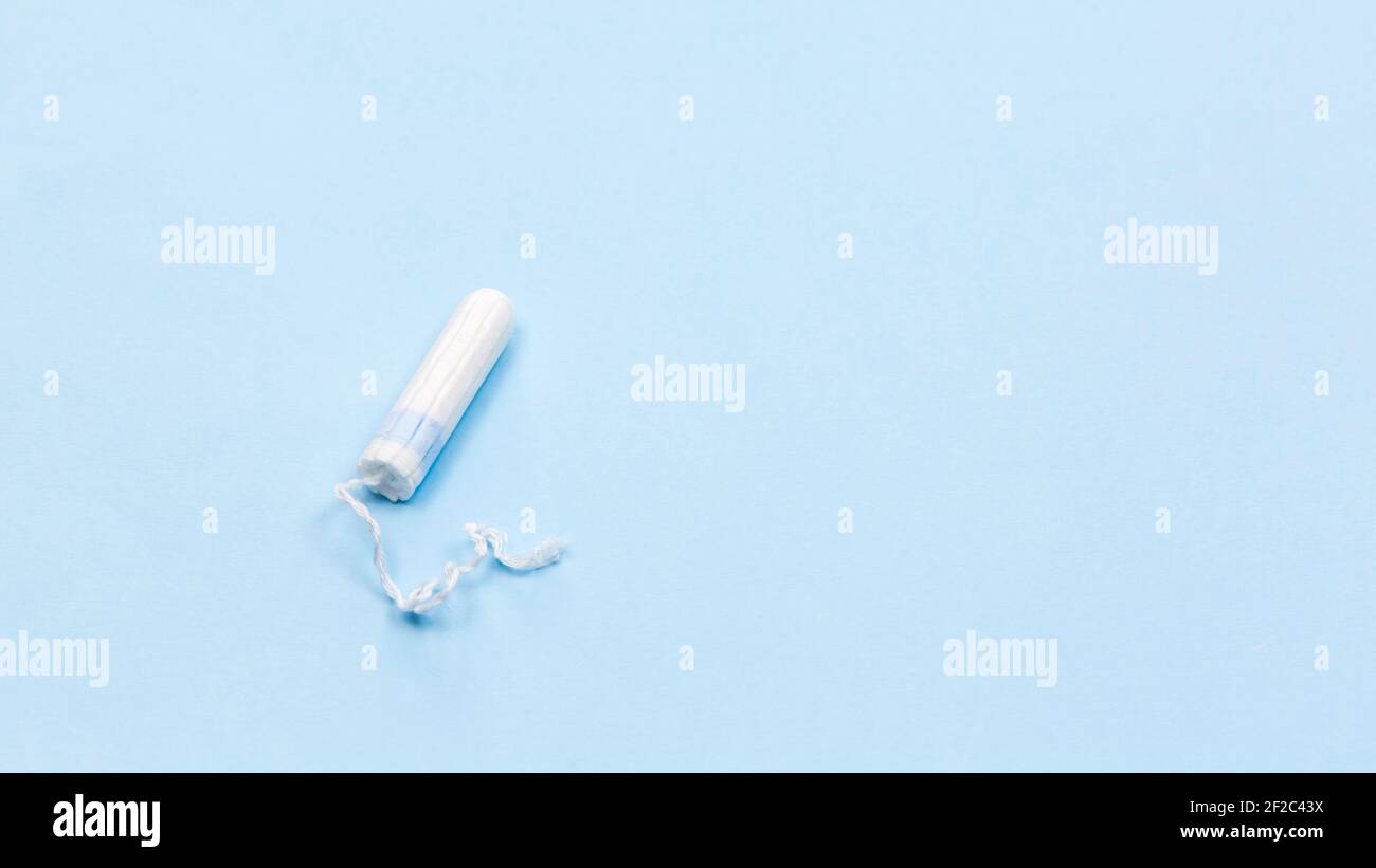 White tampon on the blue background Stock Photo - Alamy