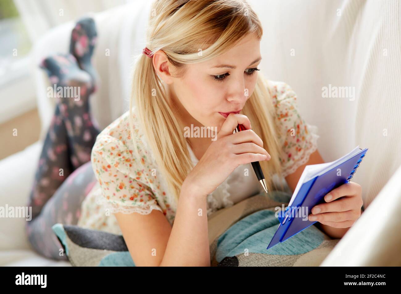 Girl writing in a diary Stock Photo - Alamy