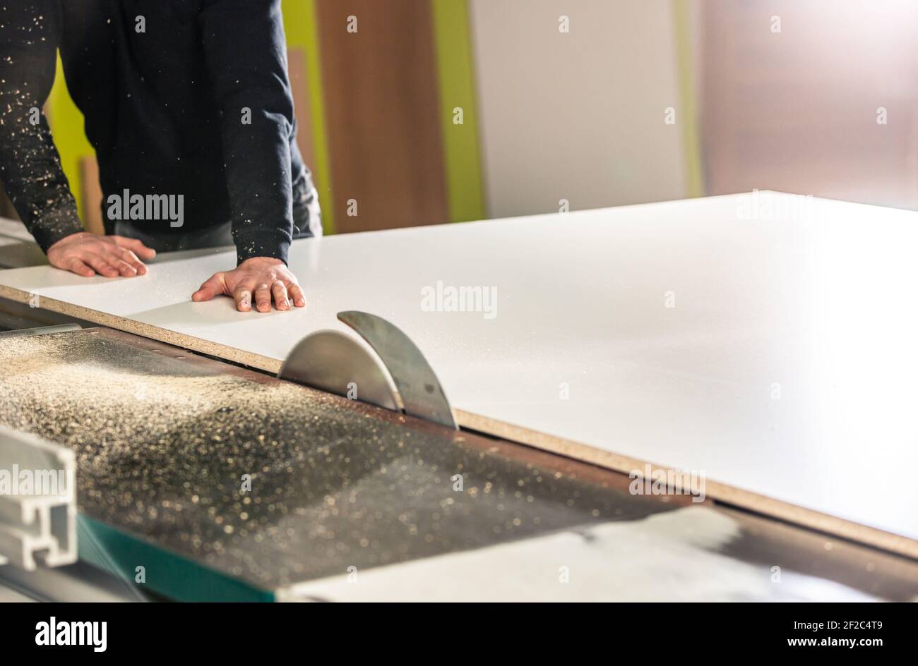 Professional carpenter cutting the wood on the huge saw for a modern ...