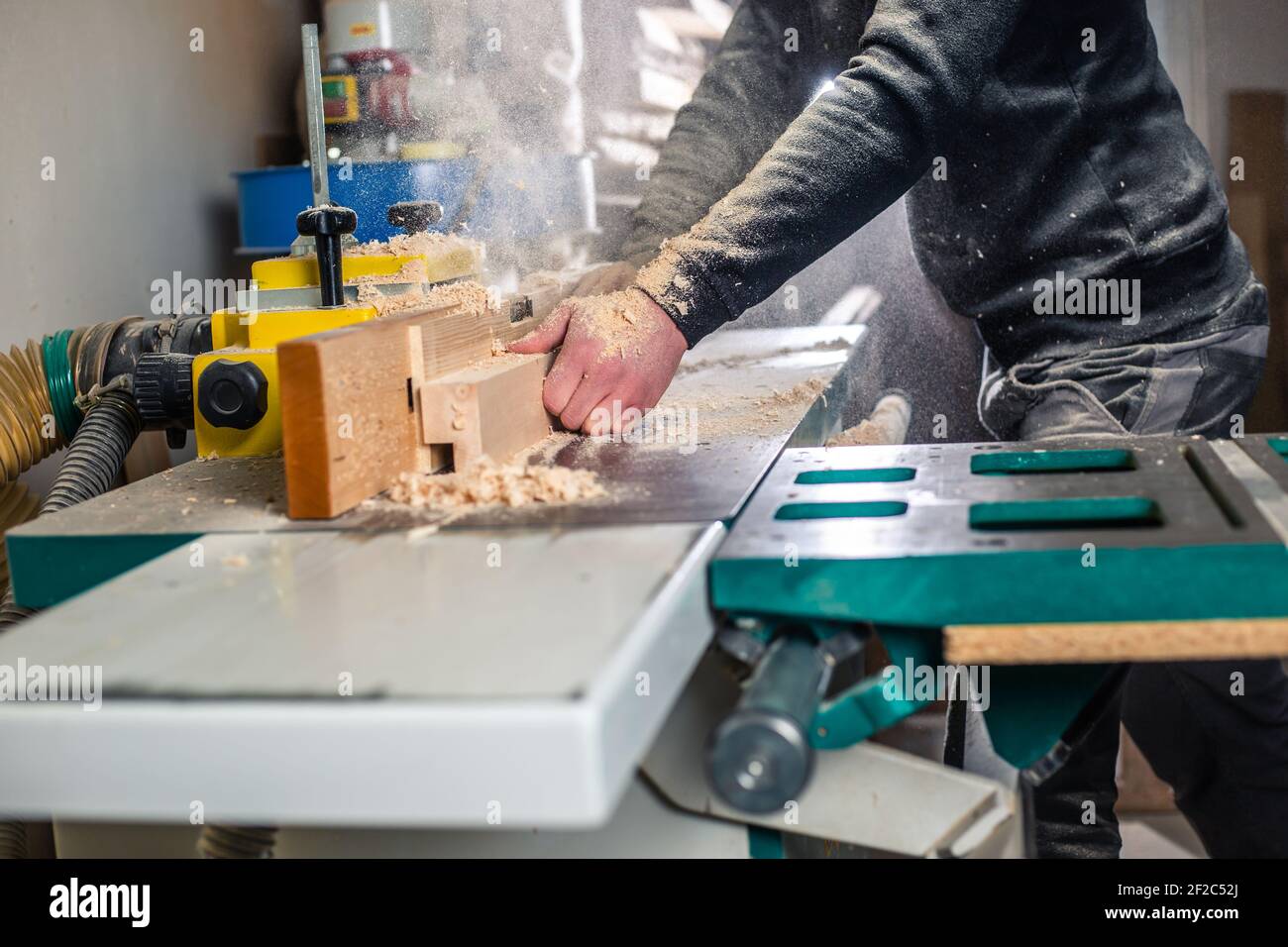 Professional carpenter cutting the wood on the huge saw for a modern ...