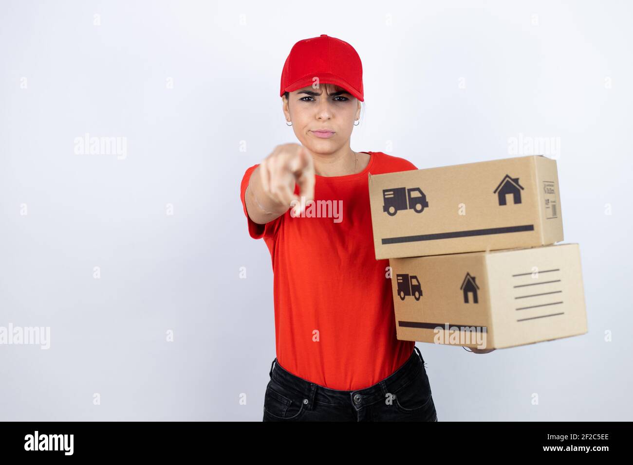 Young beautiful woman wearing courier uniform holding delivery packages ...