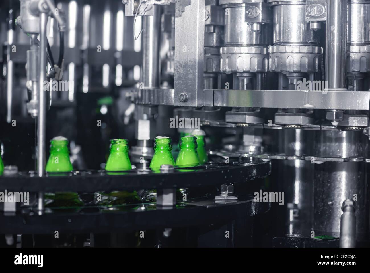 The process of filling beer into bottles on a production conveyor line ...