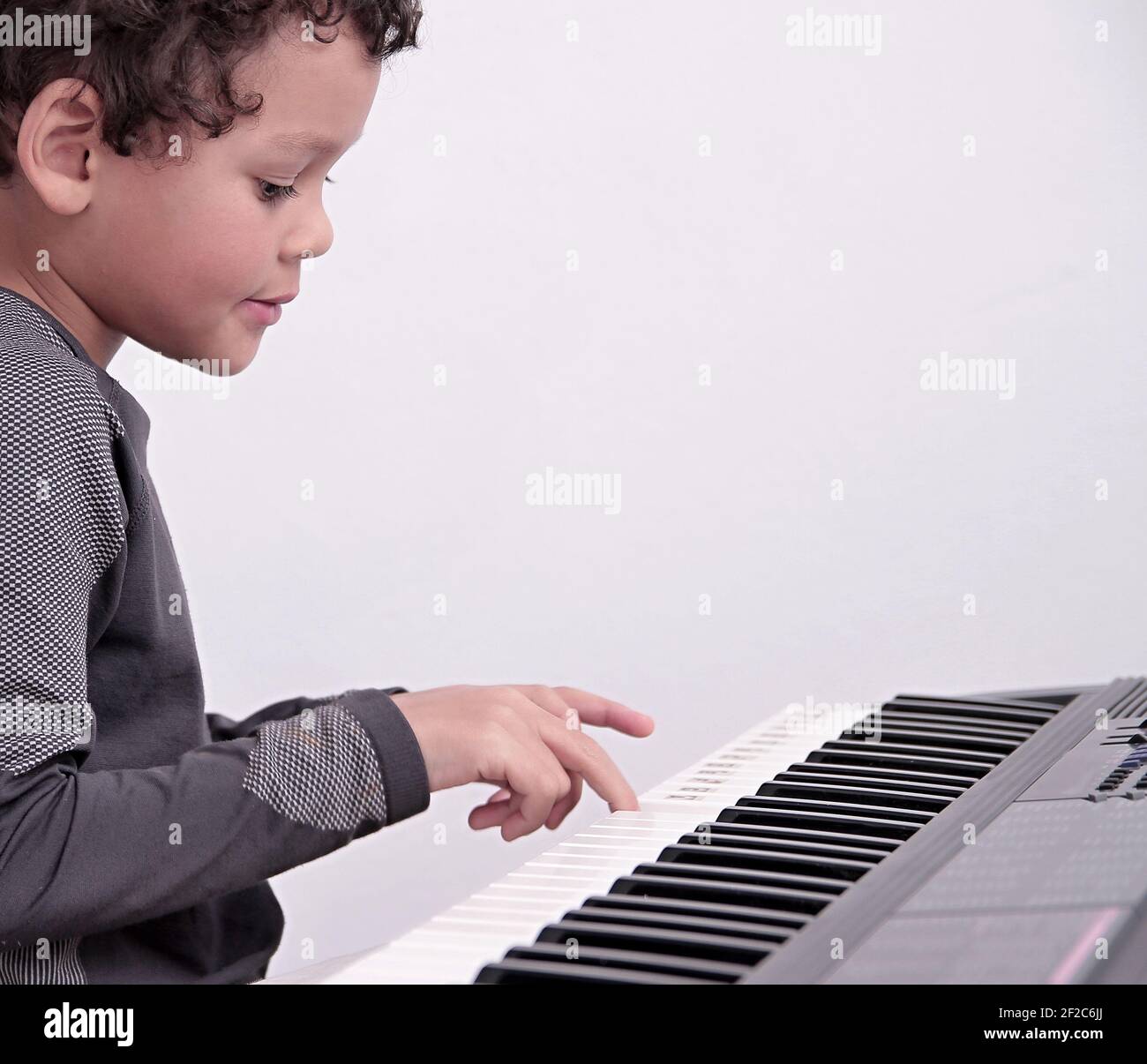 boy playing the piano keyboard with pc on white background stock photo ...