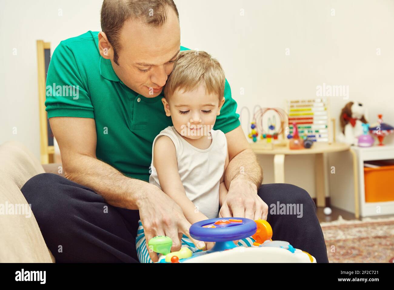 father playing with his child in developing game at home. Dad and son ...