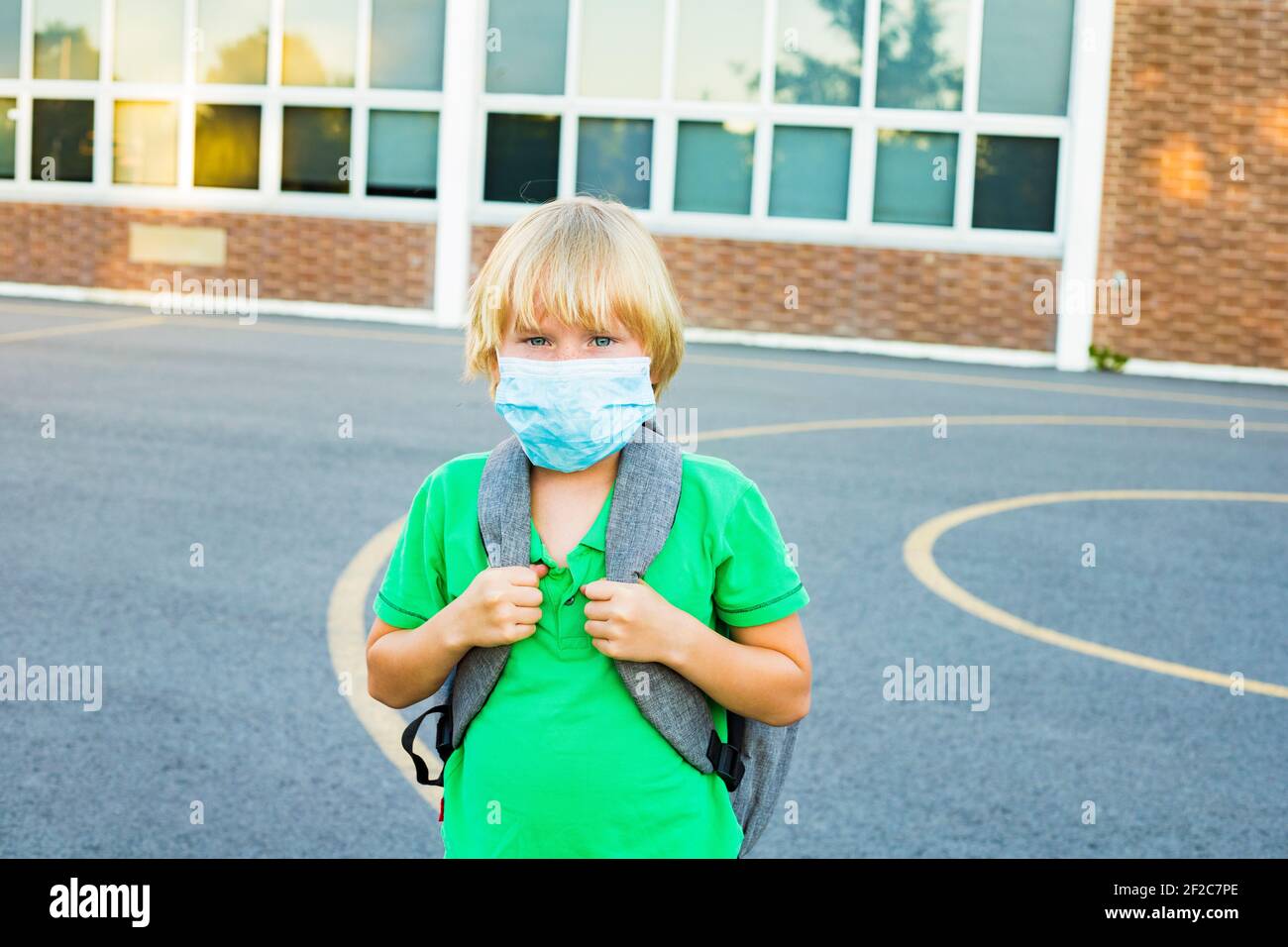 Kid in mask during corona virus outbreak. Little schoolboy wears grey ...