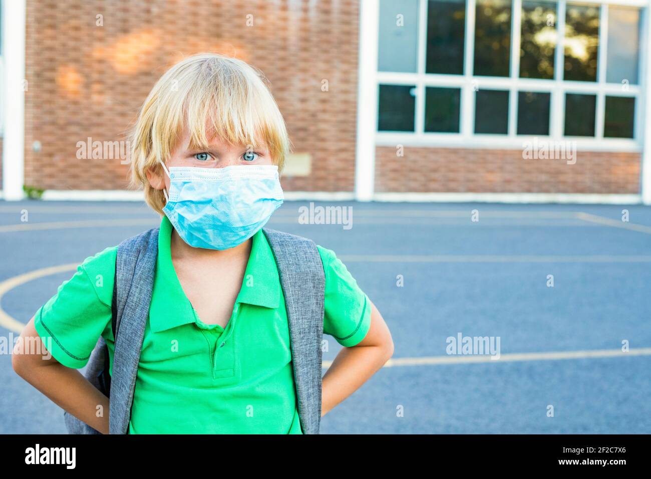 Kid in mask during corona virus outbreak. Little schoolboy wears grey ...