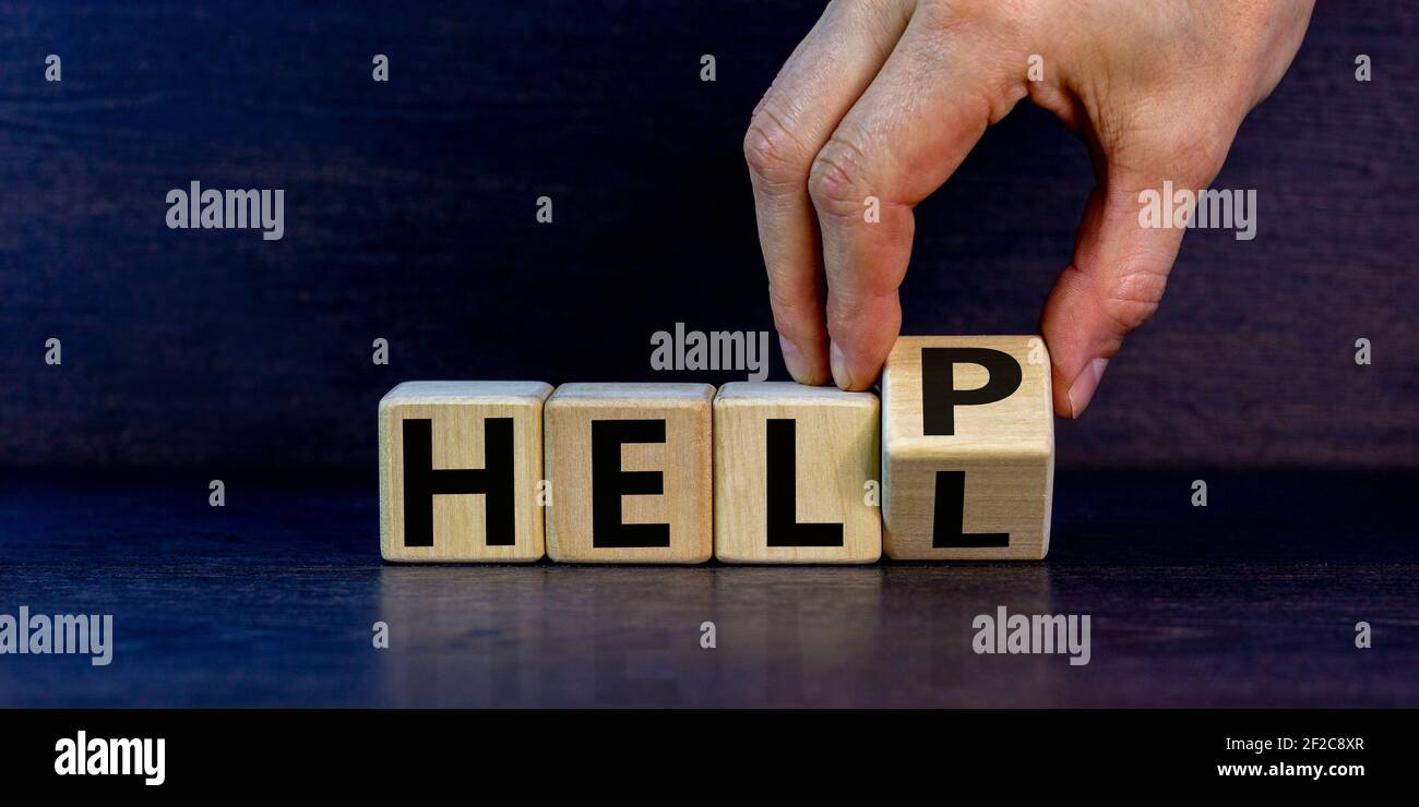 Hell or help symbol. Businessman turns a cube and changes the word ...